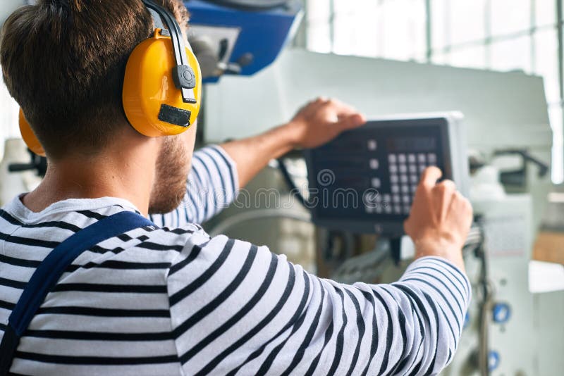 Operator Setting Up Machine Units at Factory Stock Photo - Image of ...