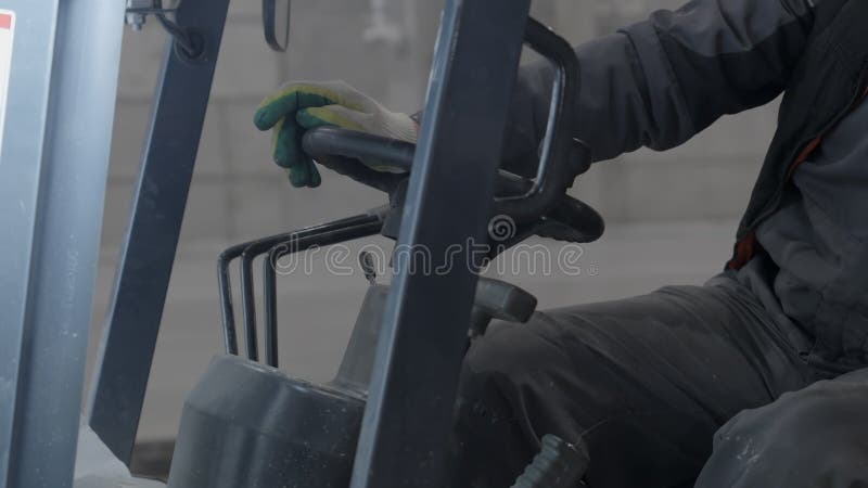 An Operator Skillfully Handling Forklift Controls while Operating in a ...