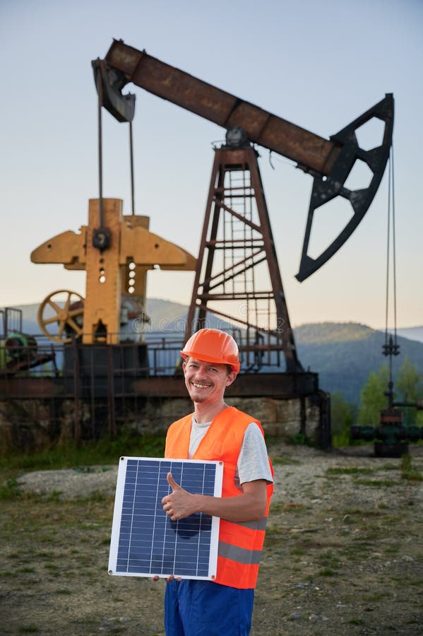 Operator with Solar Panel on the Backdrop of Pump Jack. Stock Image ...