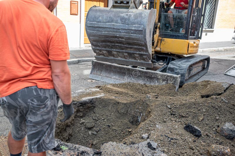 Operator Supervising Excavator while Digging in Construction Area ...