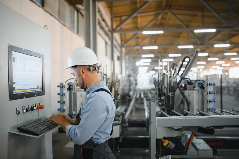 Operator Wearing Safety Hat Behind Control Panel on a Factory Stock ...