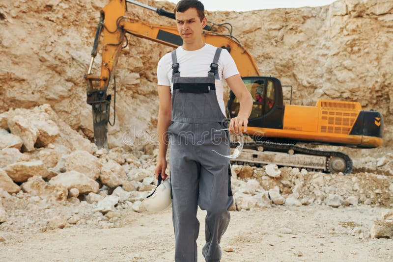 Operator is Working on the Borrow Pit. Man in Professional Uniform ...