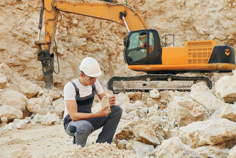 Operator is Working on the Borrow Pit. Man in Professional Uniform ...