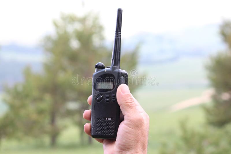 The Operator At The Workplace Allocates Workers With A Walkie-talkie ...