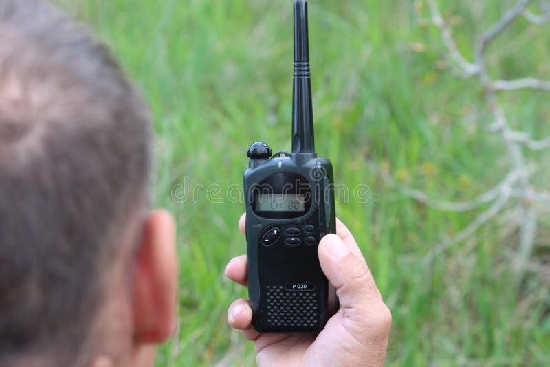 The Operator at the Workplace Allocates Workers with a Walkie-talkie ...