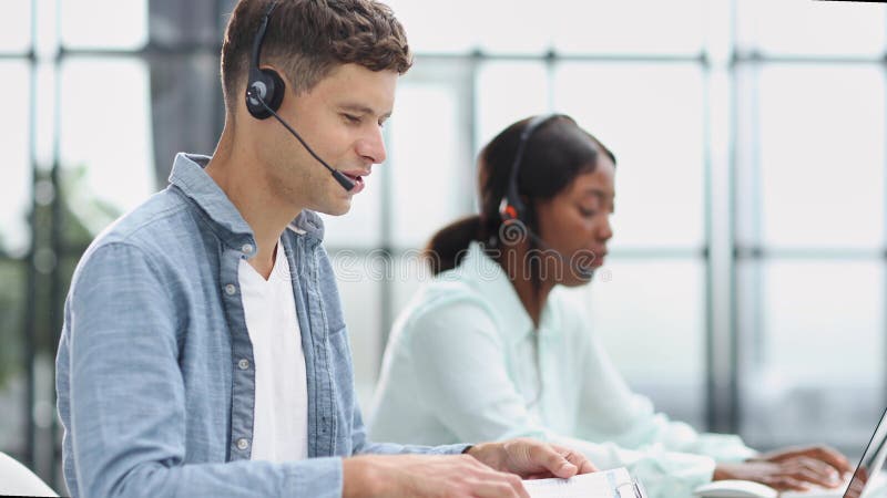 Operators Woman and Man Agent with Headsets Working in a Call Center ...