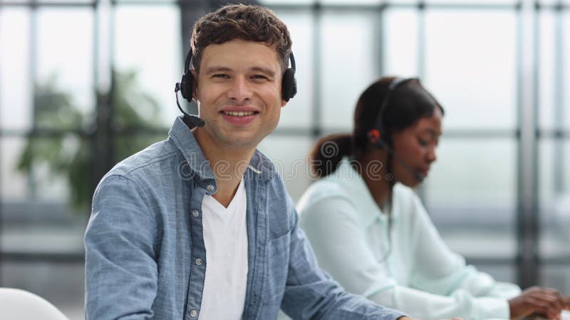 Operators Woman and Man Agent with Headsets Working in a Call Center ...