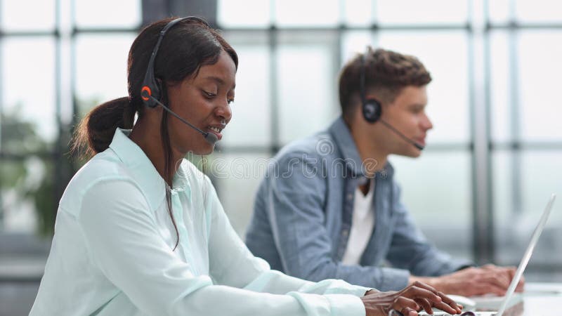 Operators Woman and Man Agent with Headsets Working in a Call Center ...