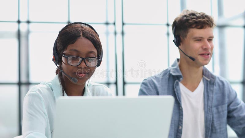 Operators Woman and Man Agent with Headsets Working in a Call Center ...