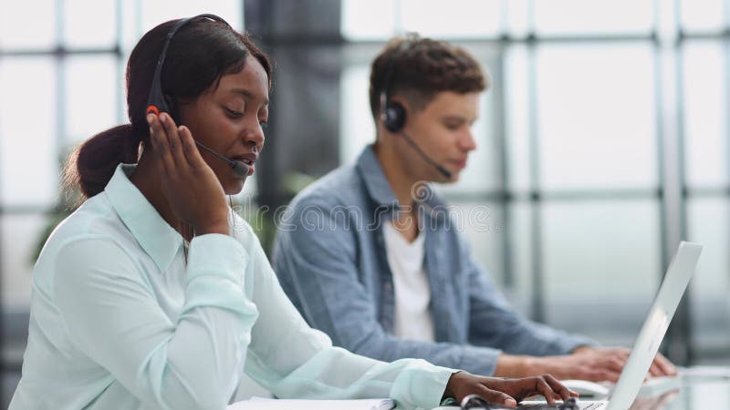 Operators Woman and Man Agent with Headsets Working in a Call Center ...