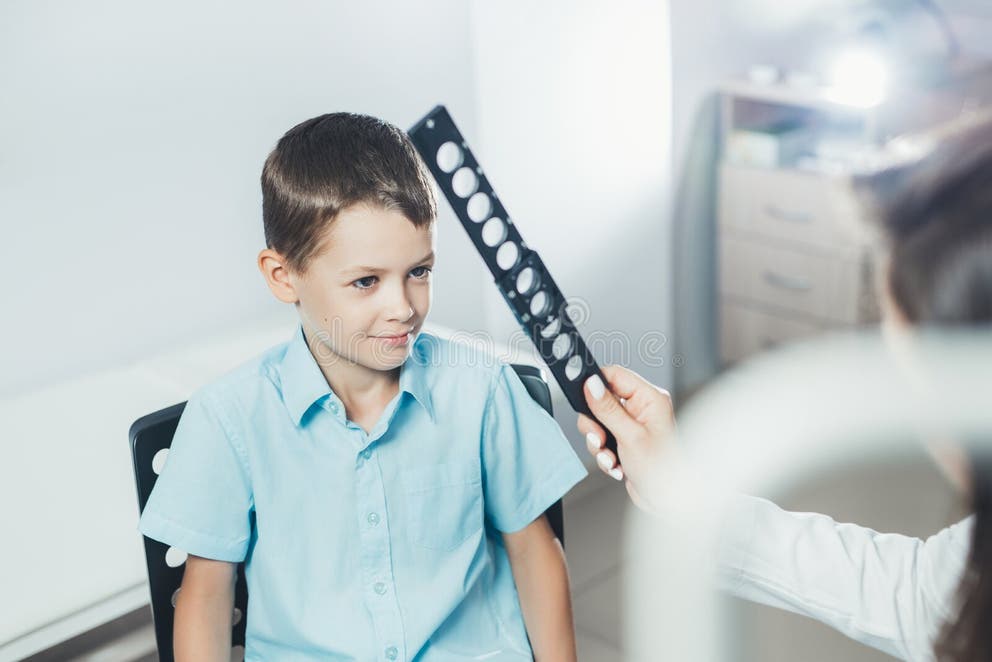 Ophthalmologist Checks the Boy`s Vision. Hyperopia. Vision Tests in ...