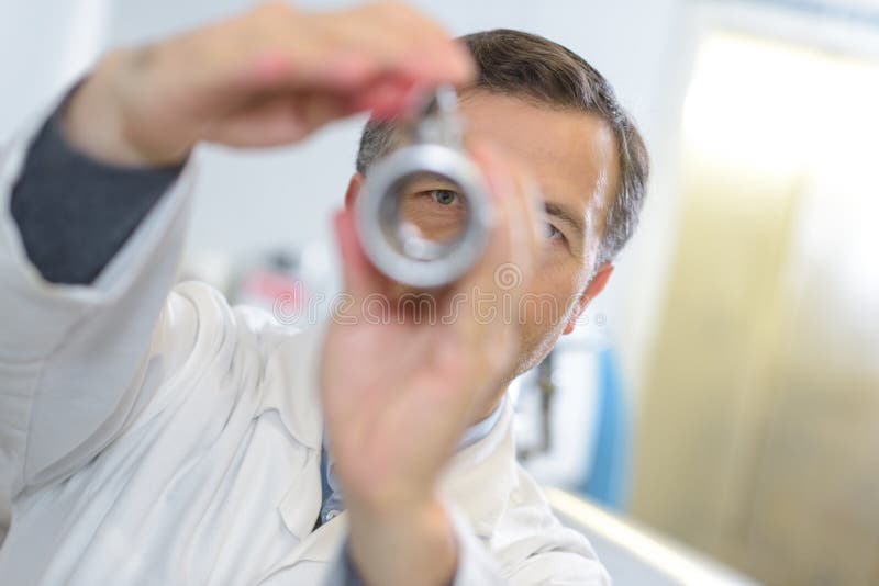 Ophthalmologist Examines Eyes with Handheld Lense Stock Image - Image ...