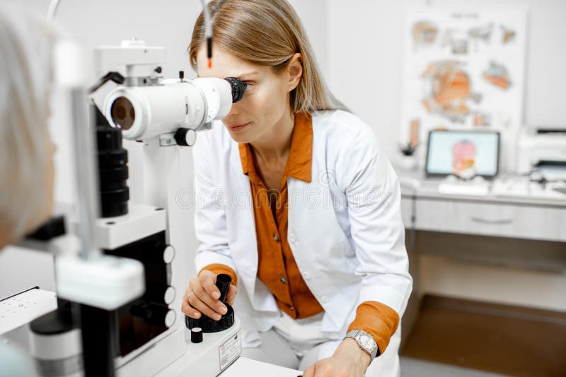 Ophthalmologist Examining Eyes with a Microscope Stock Image - Image of ...