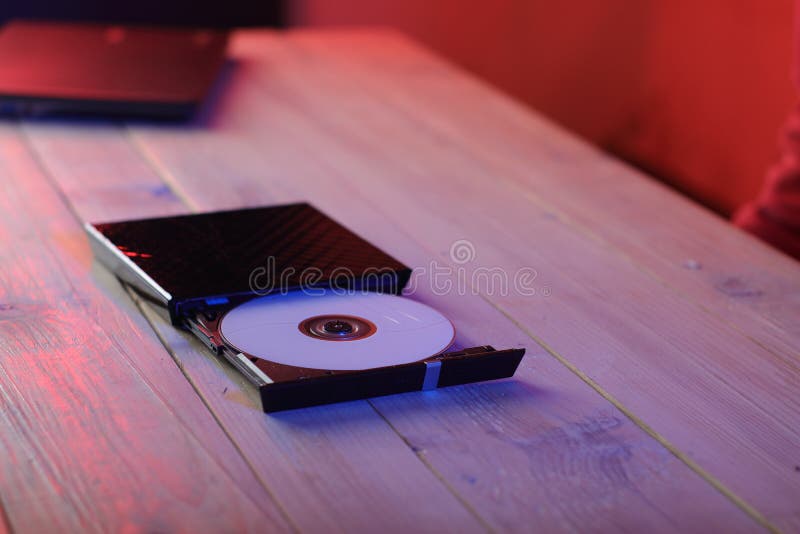Optical Drive To from Laptop with Compact Disc on Table Stock Photo ...