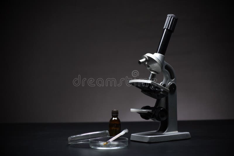 Optical Microscope on a Black Background, Petri Dish and Syringe for ...