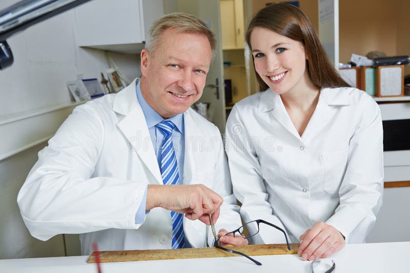 Optician and Apprentice in Workshop Stock Photo - Image of prescription ...