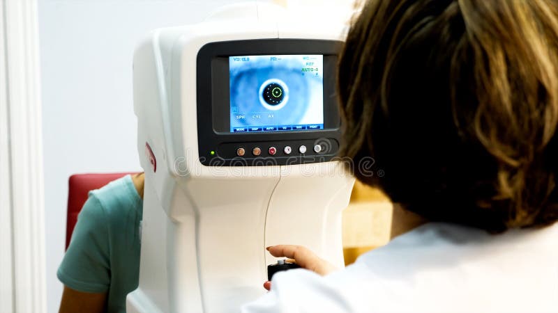 Optician Doctor Working with the Refractometer Machine. Stock Image ...