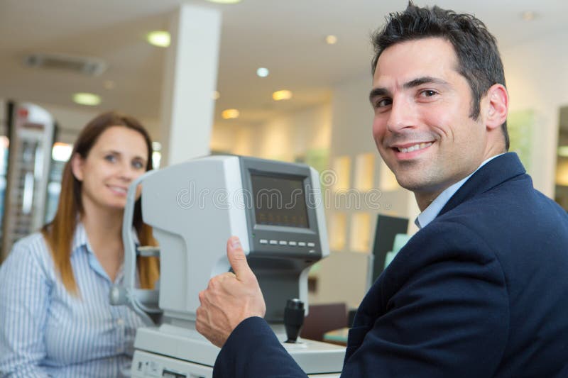 Optician Doing Scan Test To Patients Eyes Stock Image - Image of ...