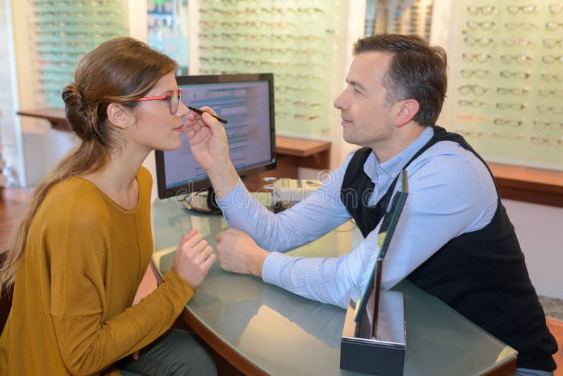 Optician Fitting Eyeglasses on Customer Stock Photo - Image of measure ...