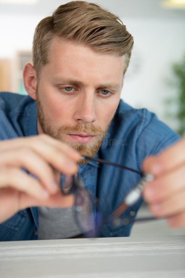 Optician Fixing Glasses with Bending Pliers Stock Image - Image of ...