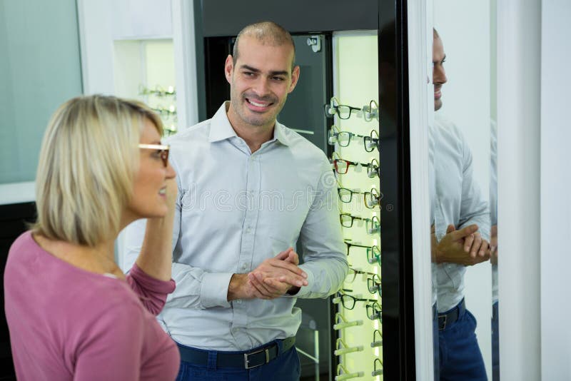 Optician Helping Customer for Selecting a Spectacles Frame Stock Photo ...
