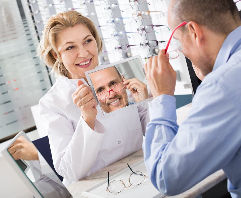 Optician Offering Glasses Frames To Client Stock Image - Image of ...