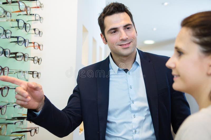 Optician Pointing at Recommended Frame Stock Photo - Image of commerce ...