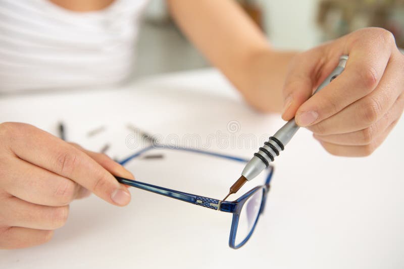 Optician Repairing Broken Glasses in Workshop Stock Photo - Image of ...