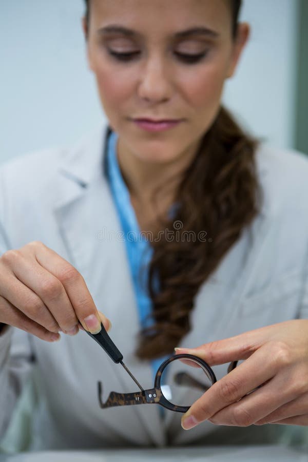 Optician Repairing Spectacles with Tool Stock Image - Image of ...