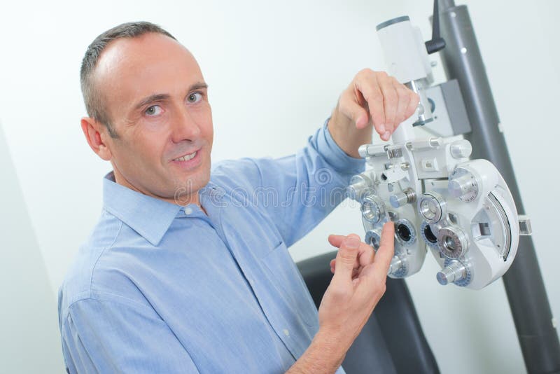 Optician Setting Up Equipment Stock Photo - Image of room, optometrist ...