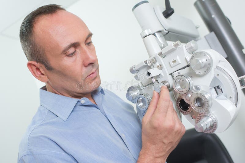 Optician Setting Up Equipment Stock Image - Image of care, instrument ...