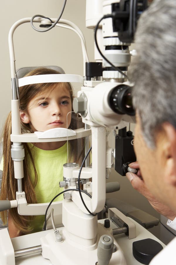 Female Optician in Surgery Giving Girl Eye Test Stock Image - Image of ...
