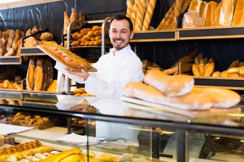 Optimistic Assistant Demonstrating Cake in Bakery Stock Photo - Image ...