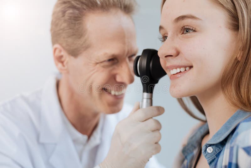 Optimistic Dermatologist Using Dermatoscope at Work Stock Photo - Image ...