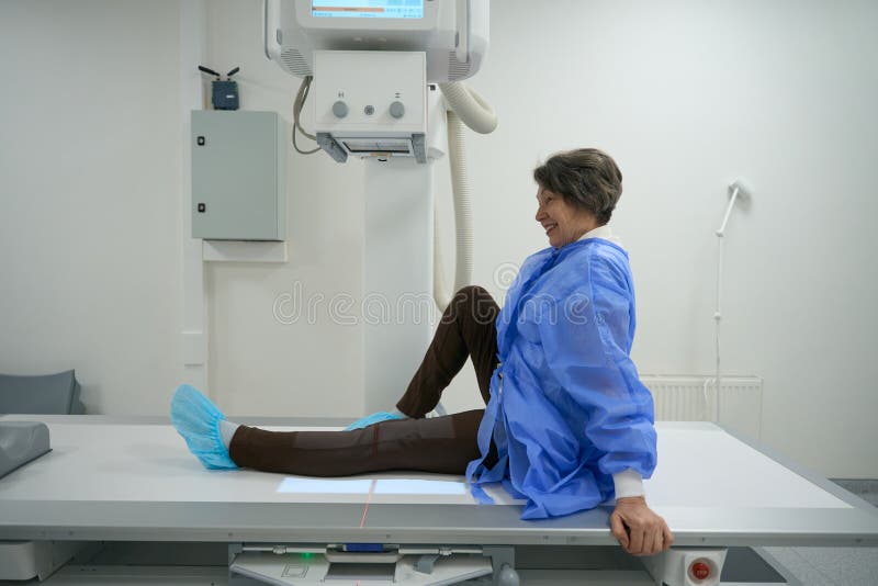 Optimistic Elderly Woman in Special Clothes is in X-ray Room Stock ...