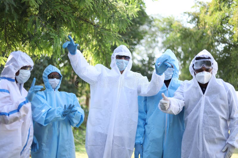 Optimistic Group of Medical Workers Wearing Protective Clothing Happily ...