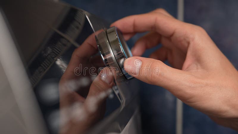 Male Hand Adjusting Settings and Selecting Washing Mode on Touch Screen ...
