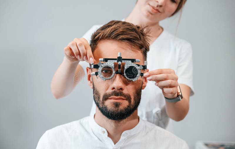 Optometric Device. Man`s Vision Checked by Female Doctor in the Clinic ...