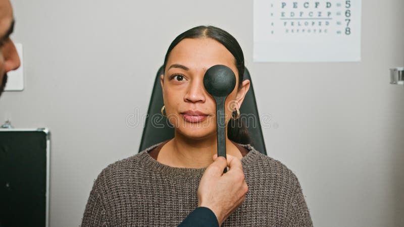 Optometrist Conducts Vision Test Using Occluder for Accurate Eye ...