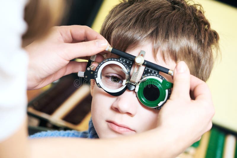 Optometrist Doctor Examines Eyesight Of Child Boy With Phoropter Stock ...