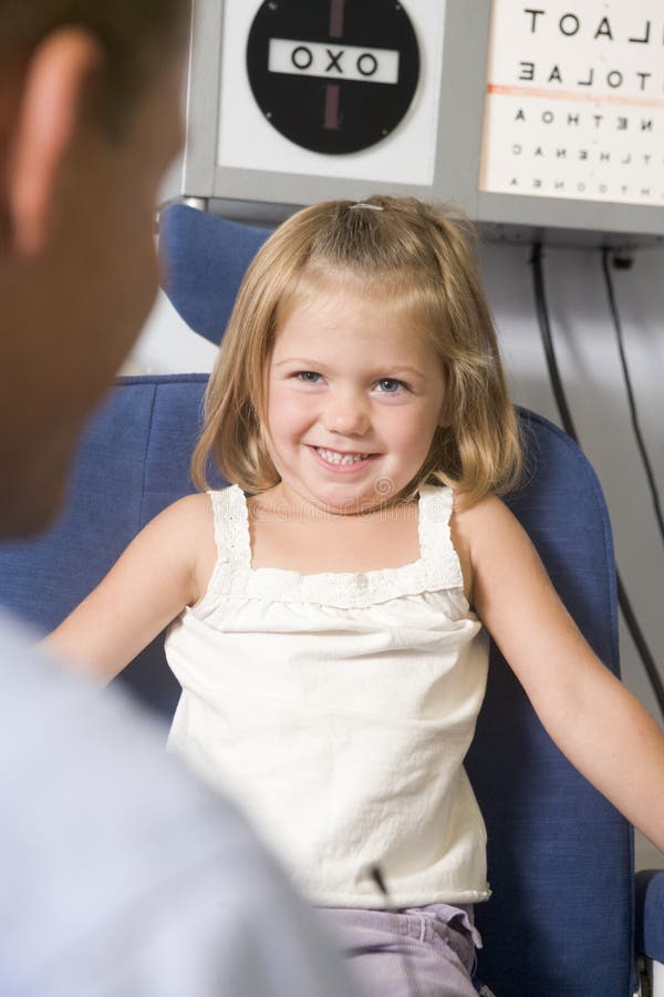 Optometrist in Exam Room with Young Girl Stock Image - Image of camera ...