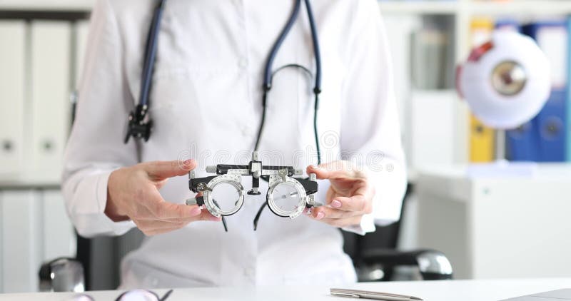 Optometrist Holds Frame for Selection of Lenses in Hospital Stock ...