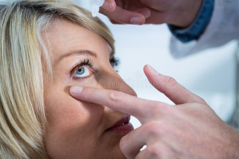 Optometrist Putting Drops into Patients Eyes Stock Image - Image of ...