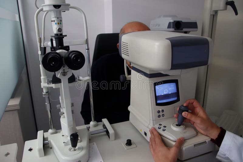 Optometrist Using Autorefractor in Clinic. Stock Photo - Image of ...