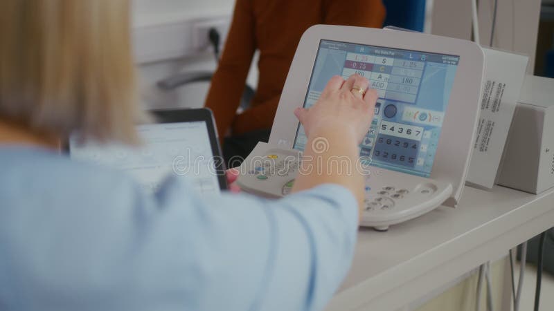 Optometrist Using Diagnostic Device during Vision Test, Modern Eye Care ...