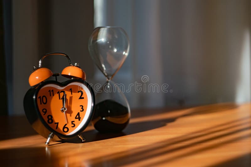 An Orange Alarm Clock is on the Table. it Shows the Dinner Time. Stock ...