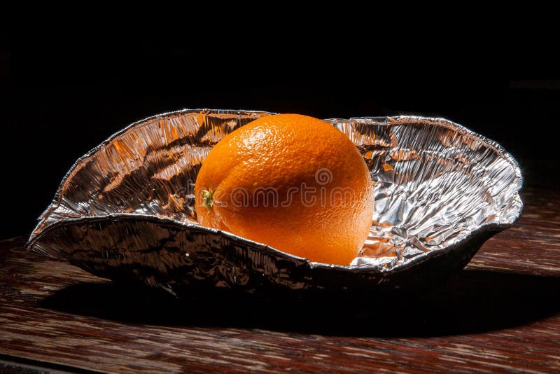 Orange in aluminium foil stock photo. Image of gourmet - 117408872