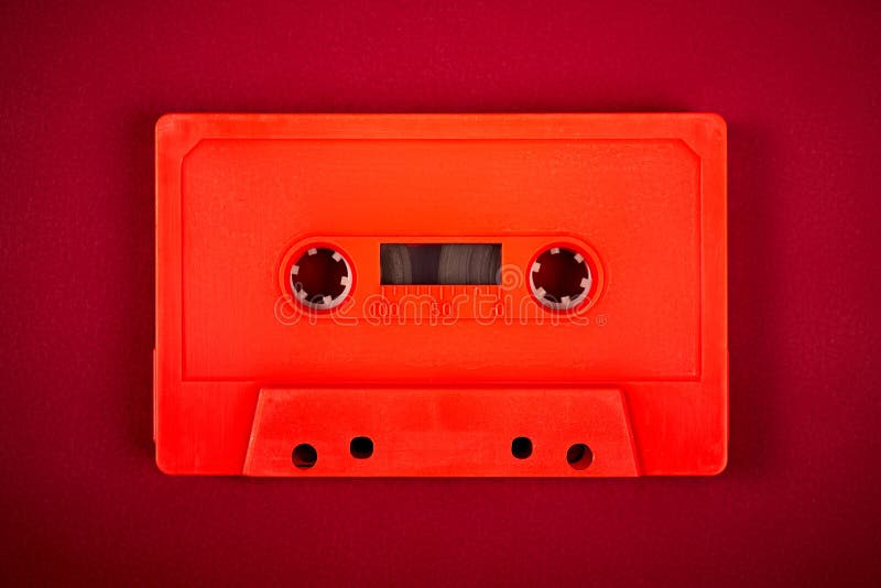 Orange Audio Cassette on the Dark Red Background Stock Image - Image of ...