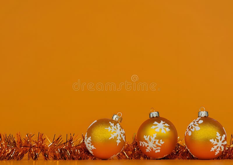 Golden Christmas Baubles with Tinsel on Orange Background Stock ...