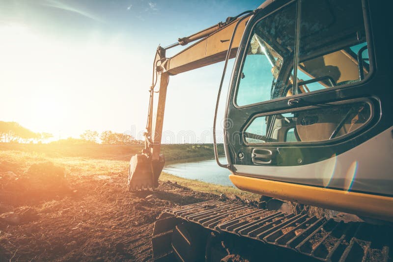 Orange Backhoe is on the Ground with Sunset Stock Photo - Image of ...